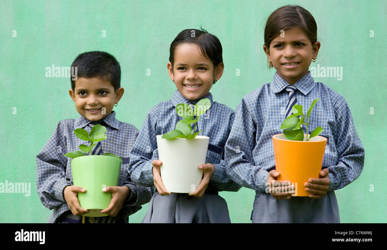 School girls holding potted plants Stock Photo - Alamy