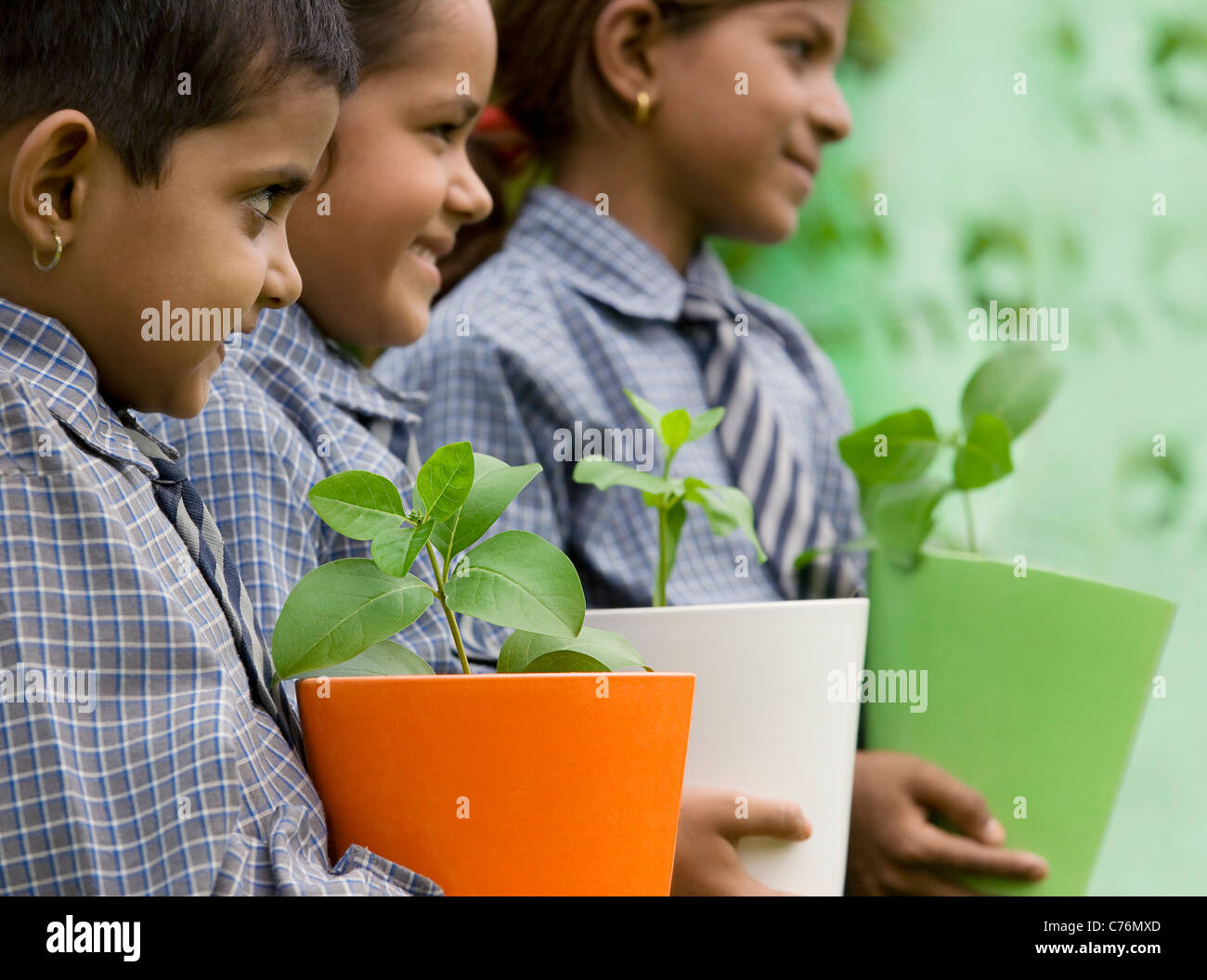 School girls holding potted plants Stock Photo - Alamy