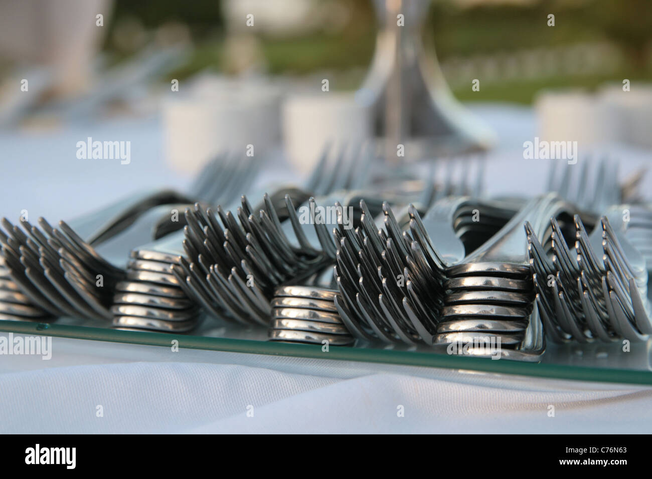 Many forks ready to be used in a banquet outdoors Stock Photo - Alamy