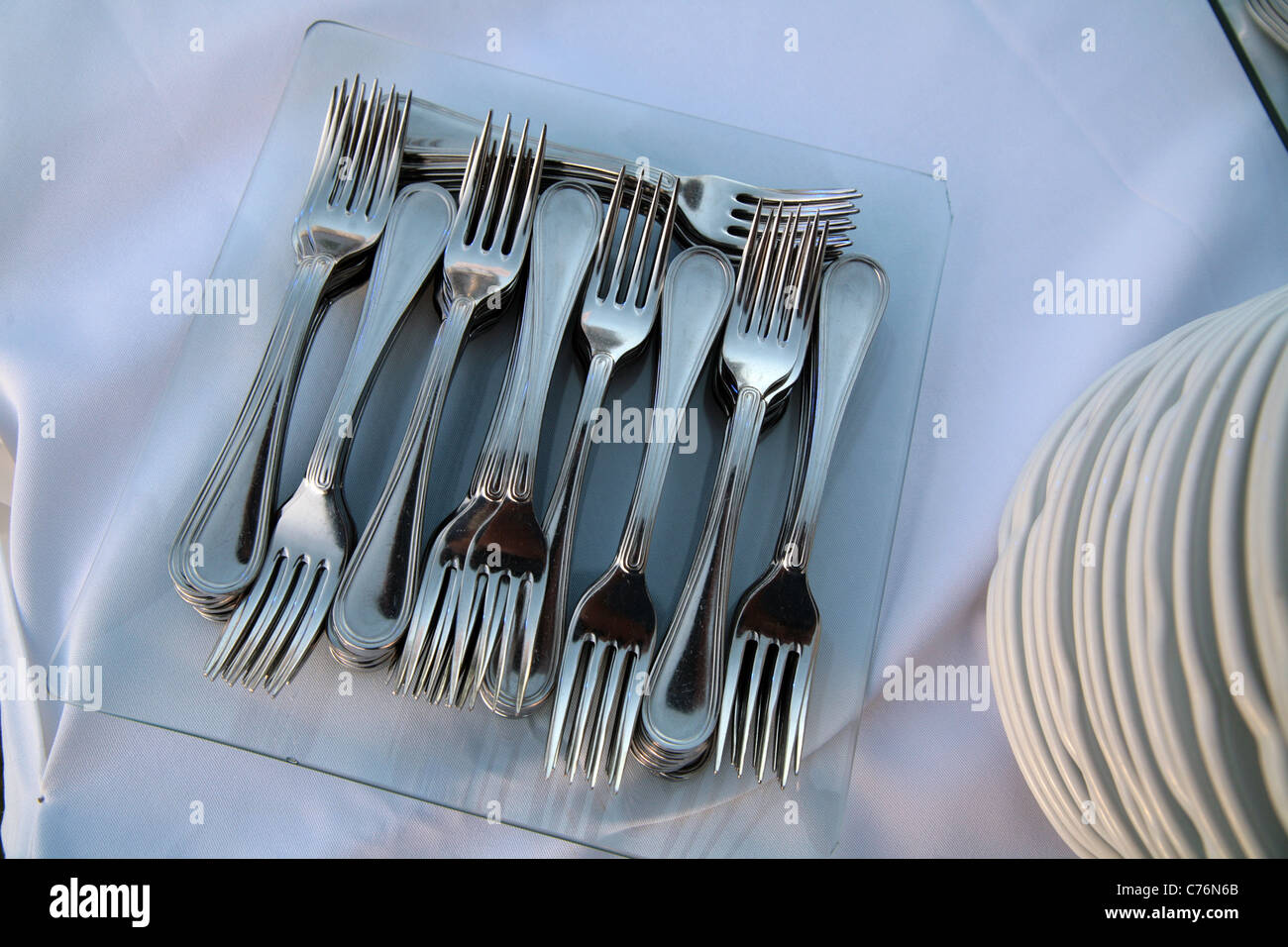 Many forks ready to be used in a banquet outdoors Stock Photo - Alamy