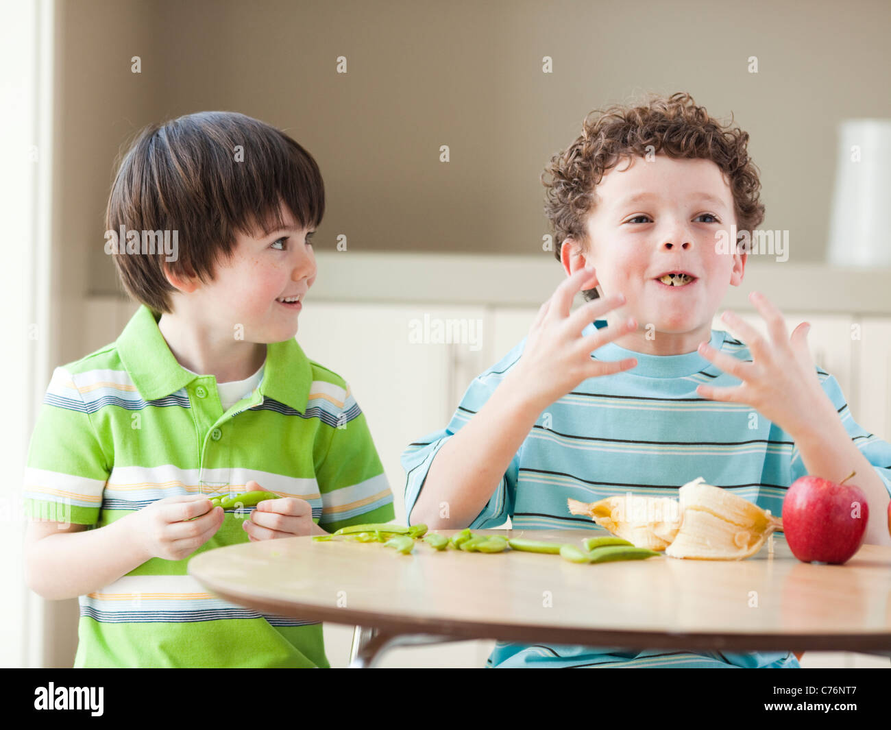 Two boys sitting kitchen eating under hi-res stock photography and ...