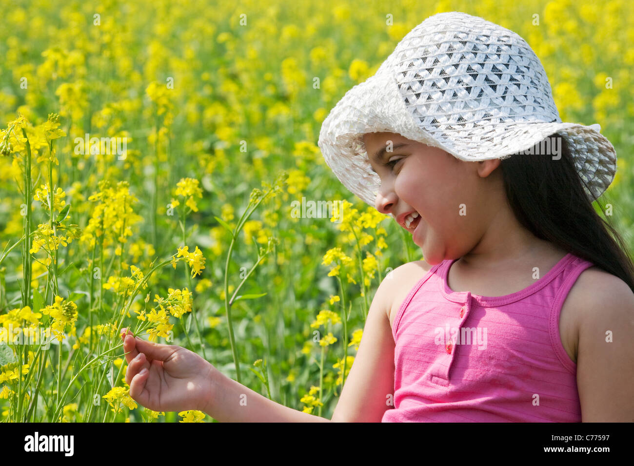 Young girl looking at flowers Stock Photo - Alamy