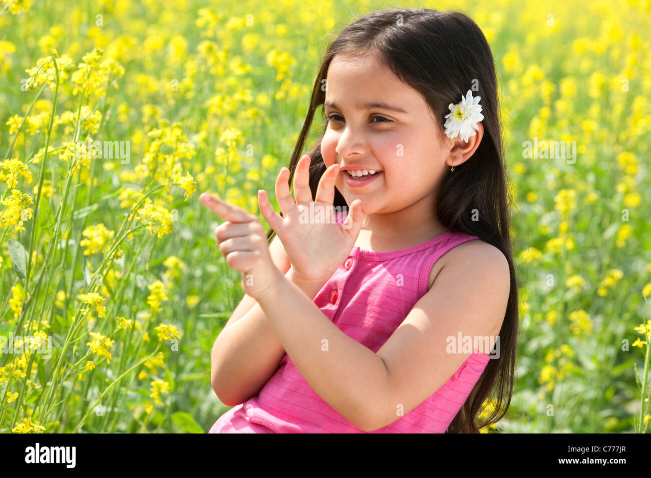 Young girl having fun in a field Stock Photo - Alamy