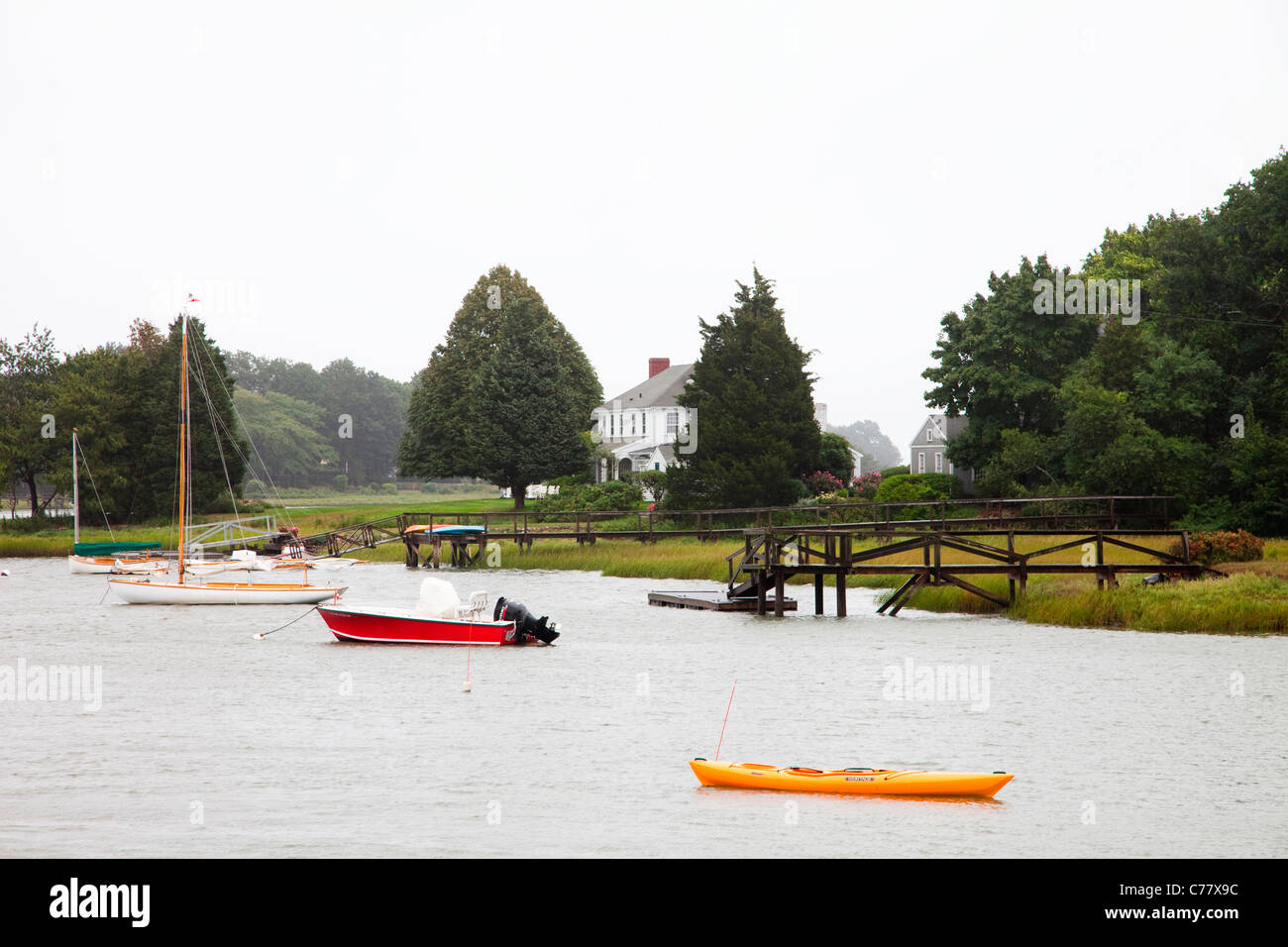 Boats float in a small inlet on a cloudy day Stock Photo - Alamy