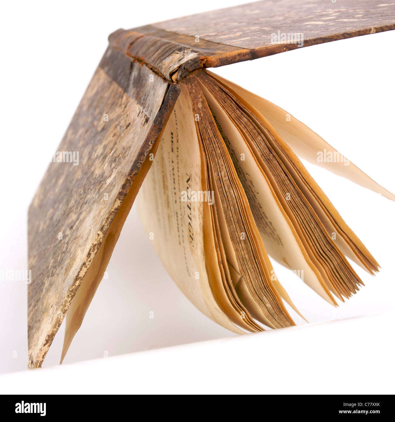 Old book with worn pages and a textured cover resting on a surface ...