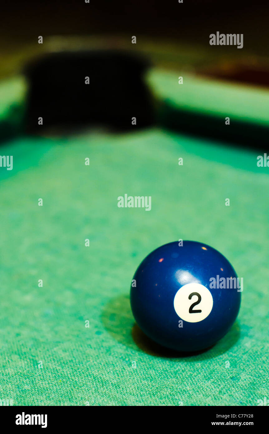 a close up of billiard ball number 2, solid blue, for conceptual usage ...