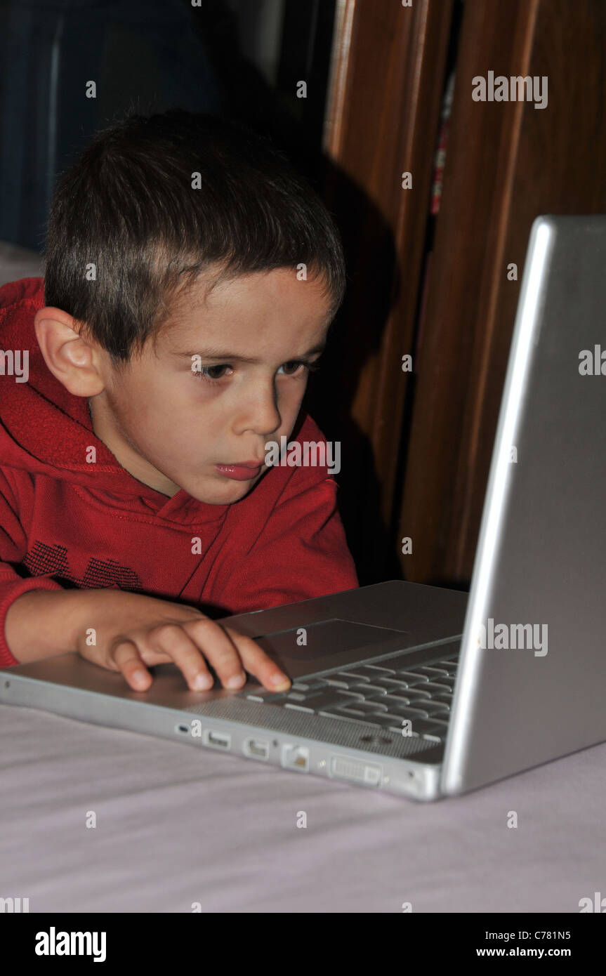 young boy looking at his computer Stock Photo - Alamy