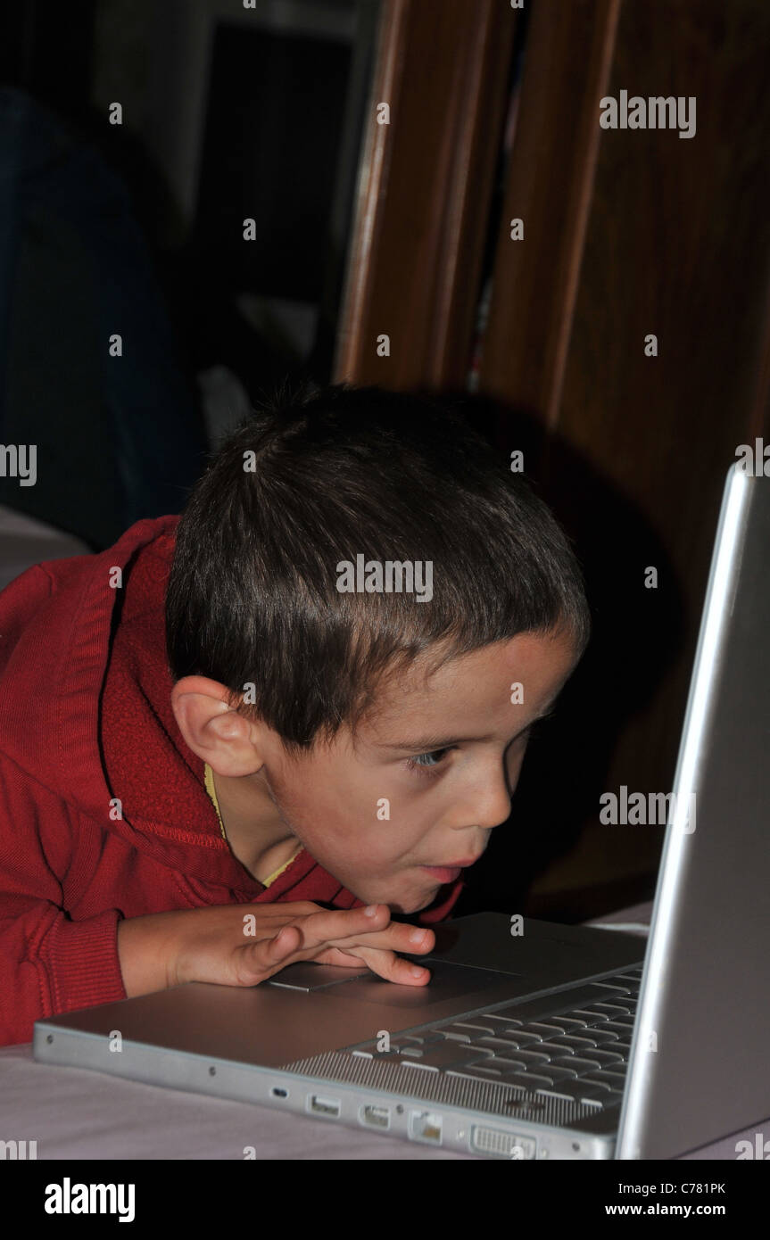 young boy looking at his computer Stock Photo - Alamy