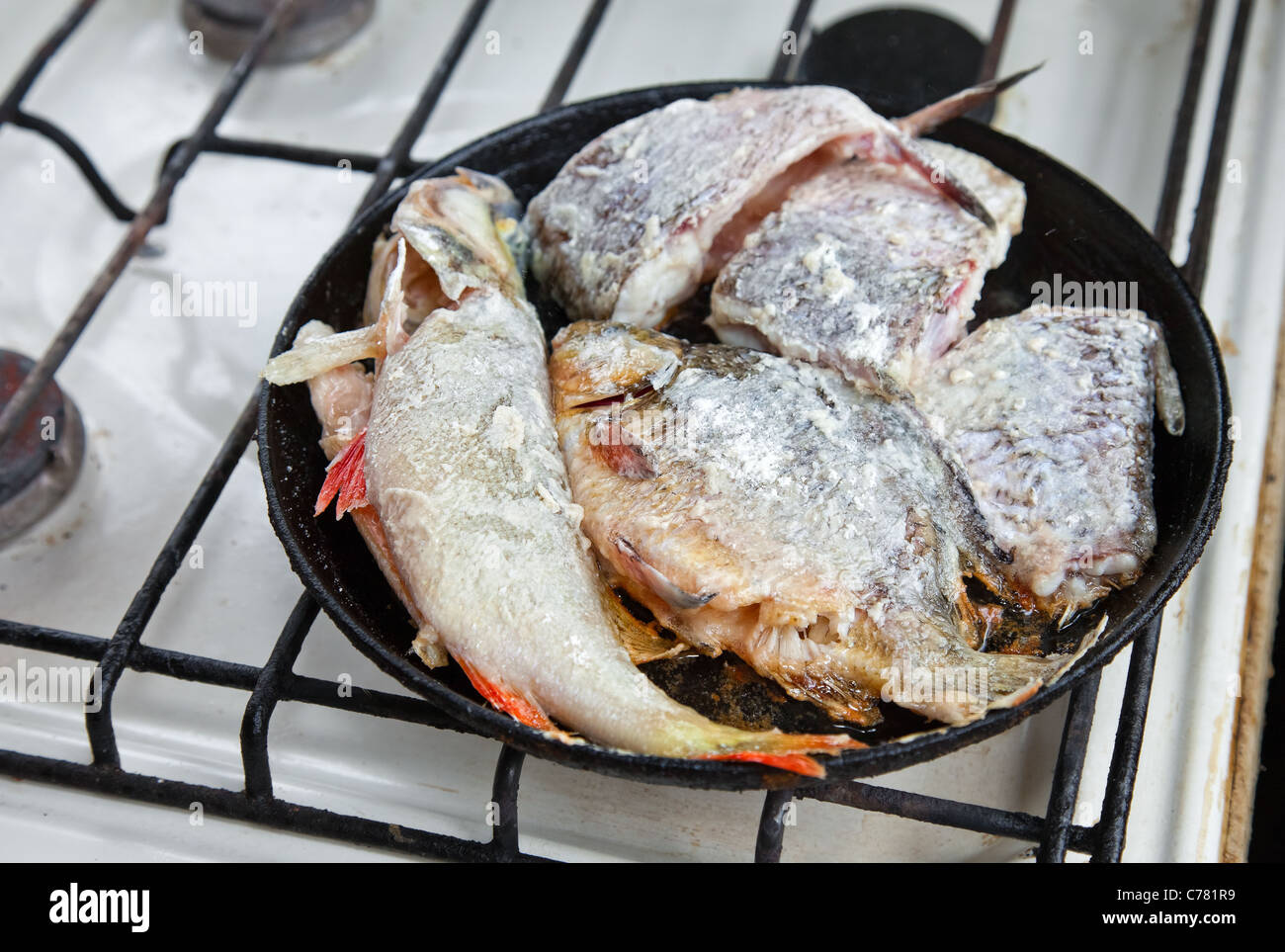 Fried fish in a frying pan Stock Photo - Alamy