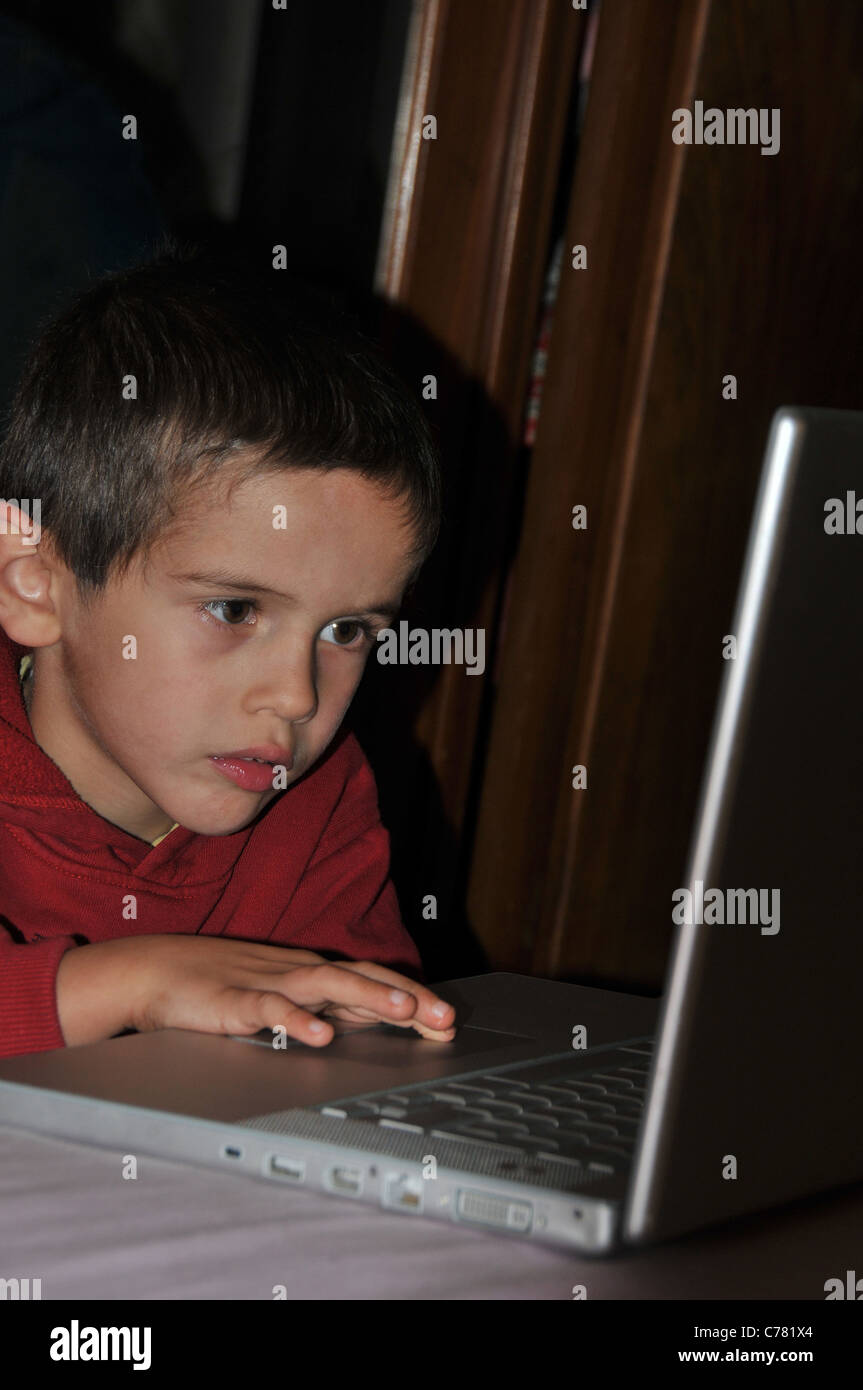 young boy looking at his computer Stock Photo - Alamy