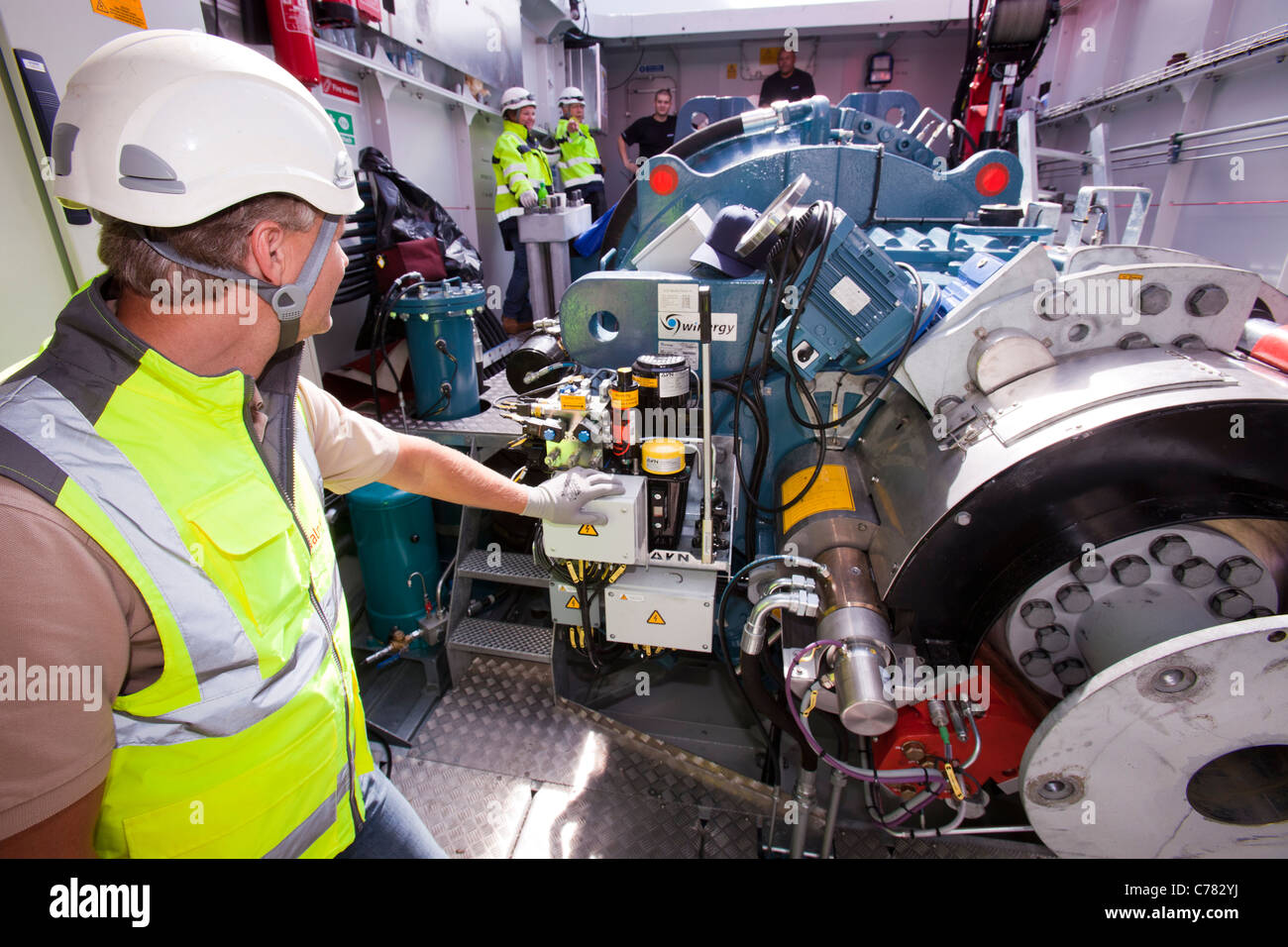 Engineers in the nacelle of a wind turbine in the Walney offshore wind ...