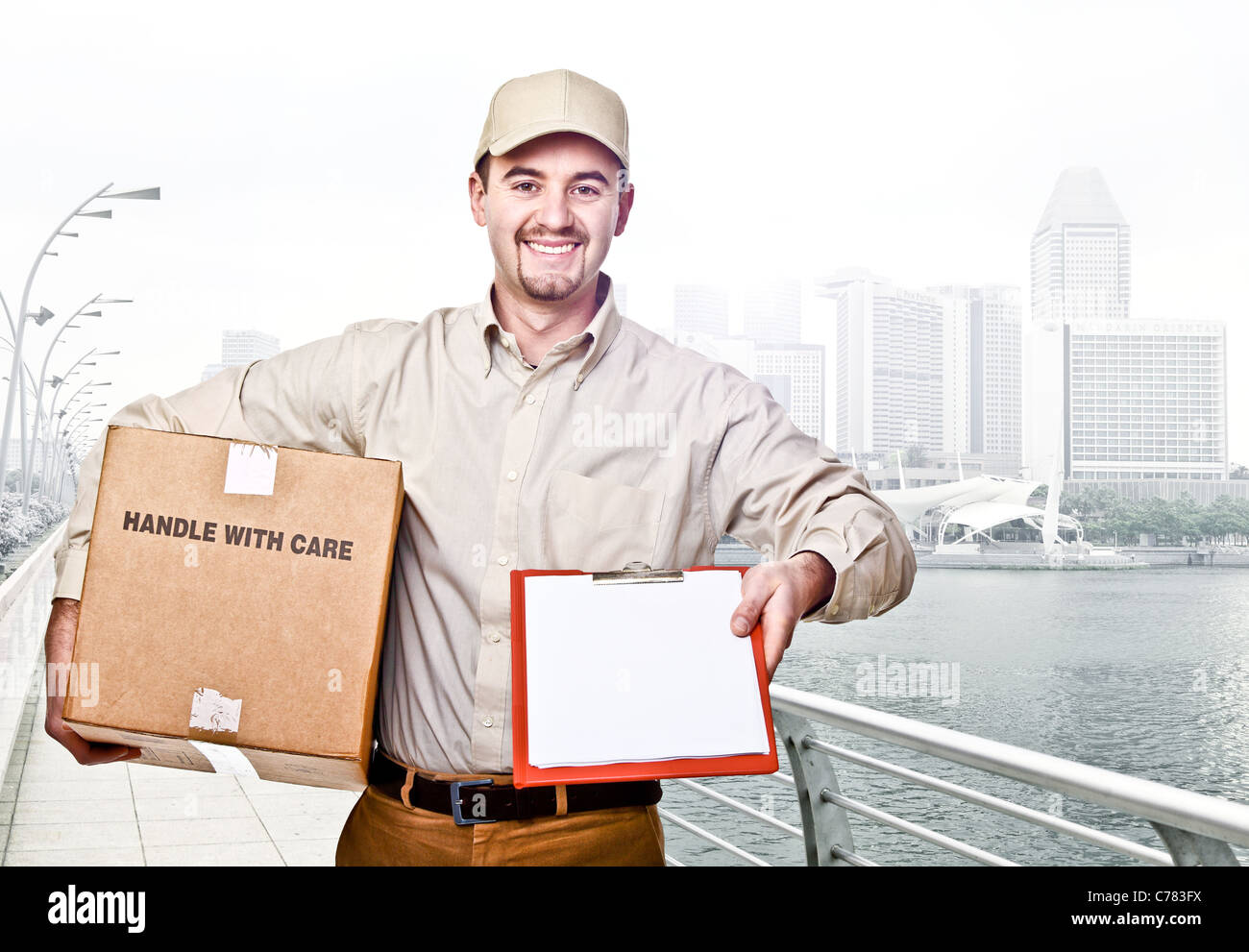 smiling delivery man and modern town background Stock Photo - Alamy
