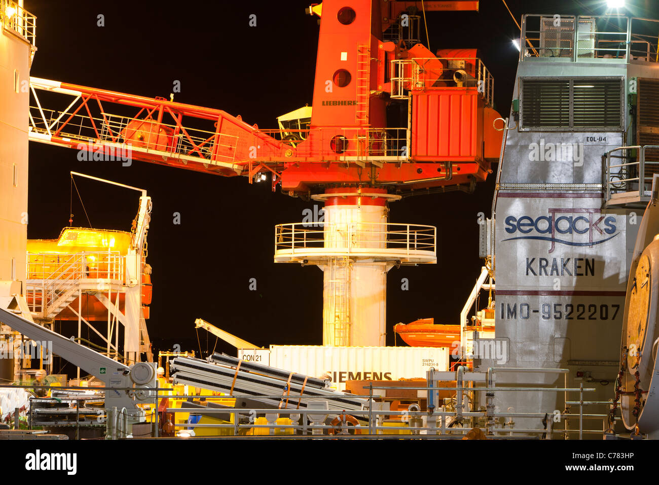 loading a jack up barge with wind turbine parts at night in Mostyn, for ...