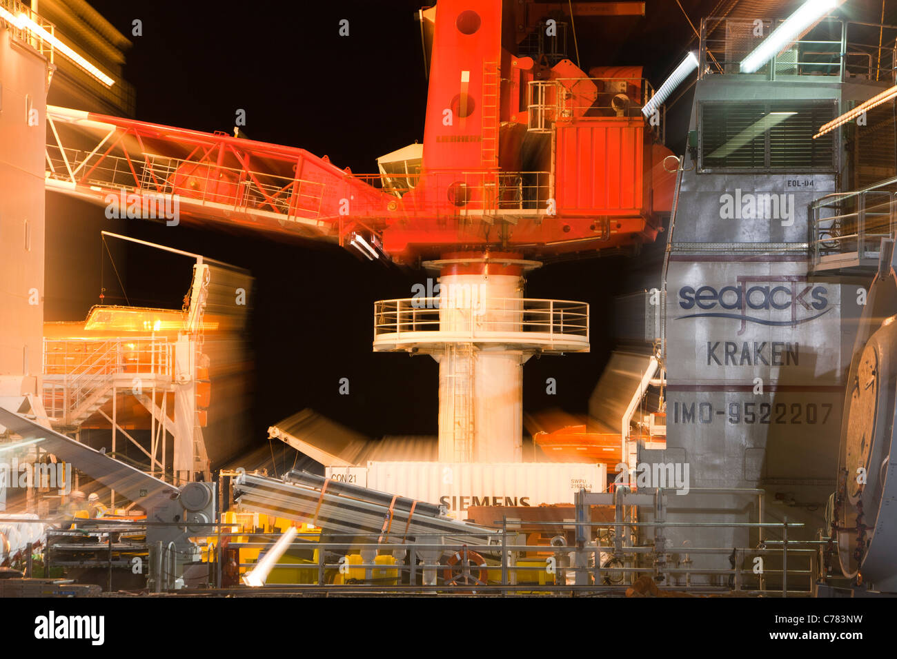 loading a jack up barge with wind turbine parts at night in Mostyn, for ...