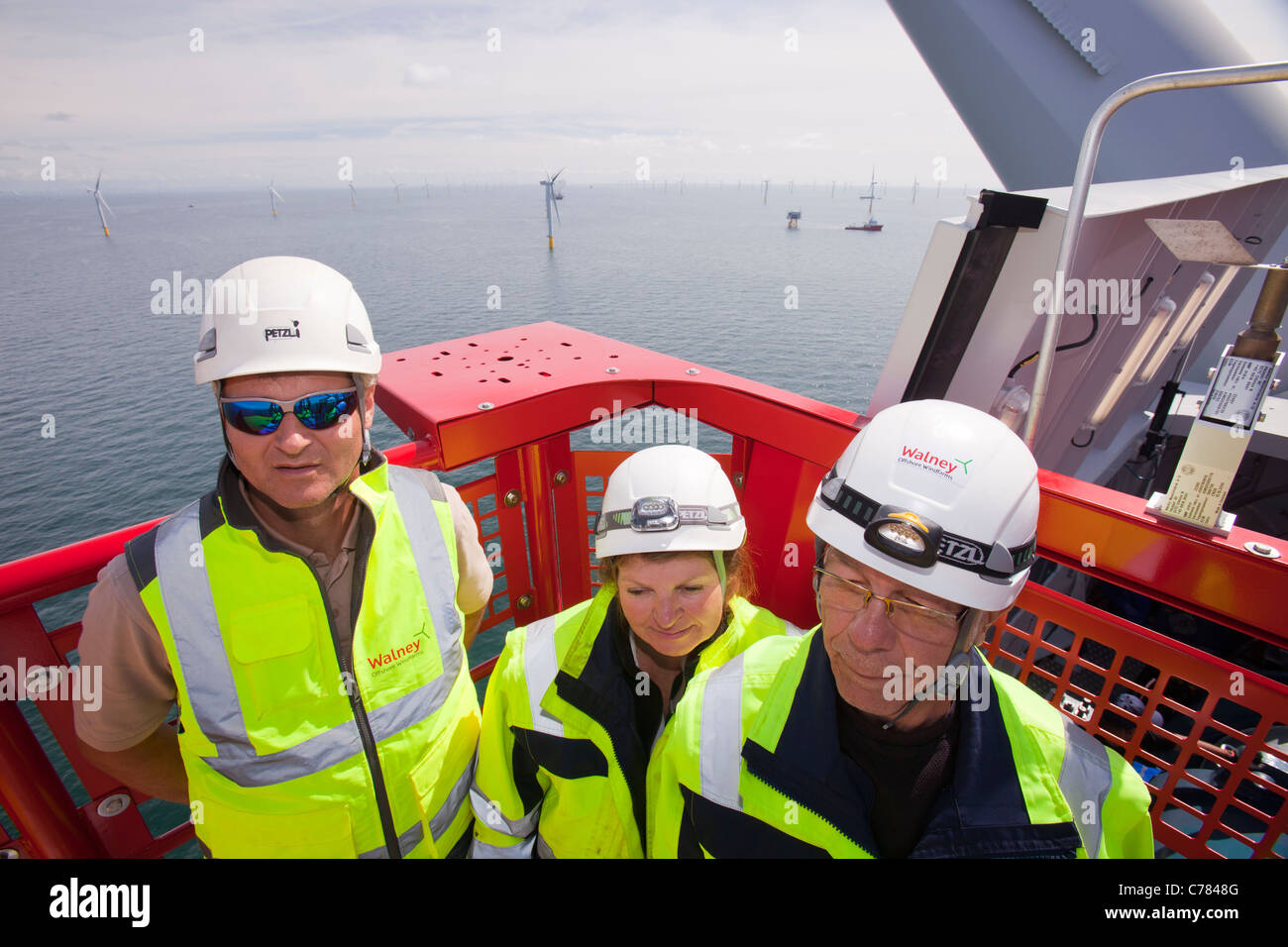 health and safety workers on top of a nacelle on a wind turbine in the ...