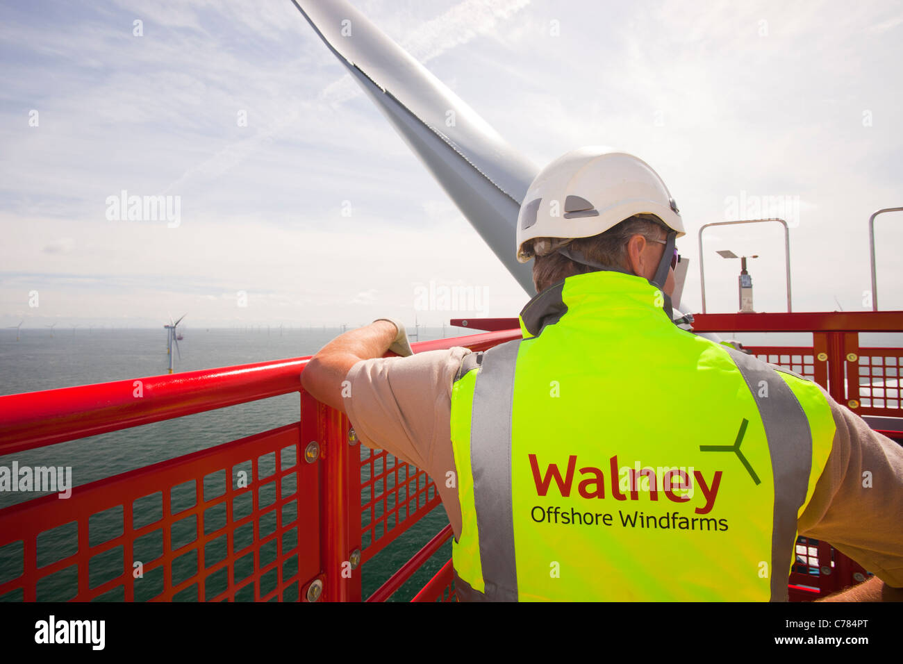 health and safety workers on top of a nacelle on a wind turbine in the ...