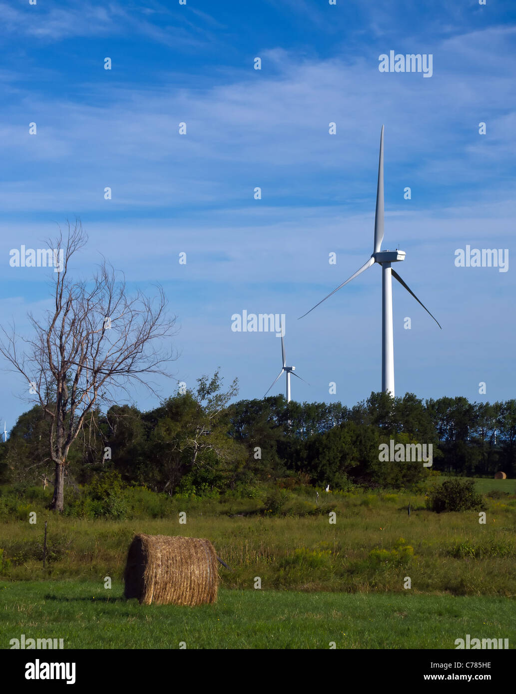 Wind turbines near hay field Stock Photo - Alamy