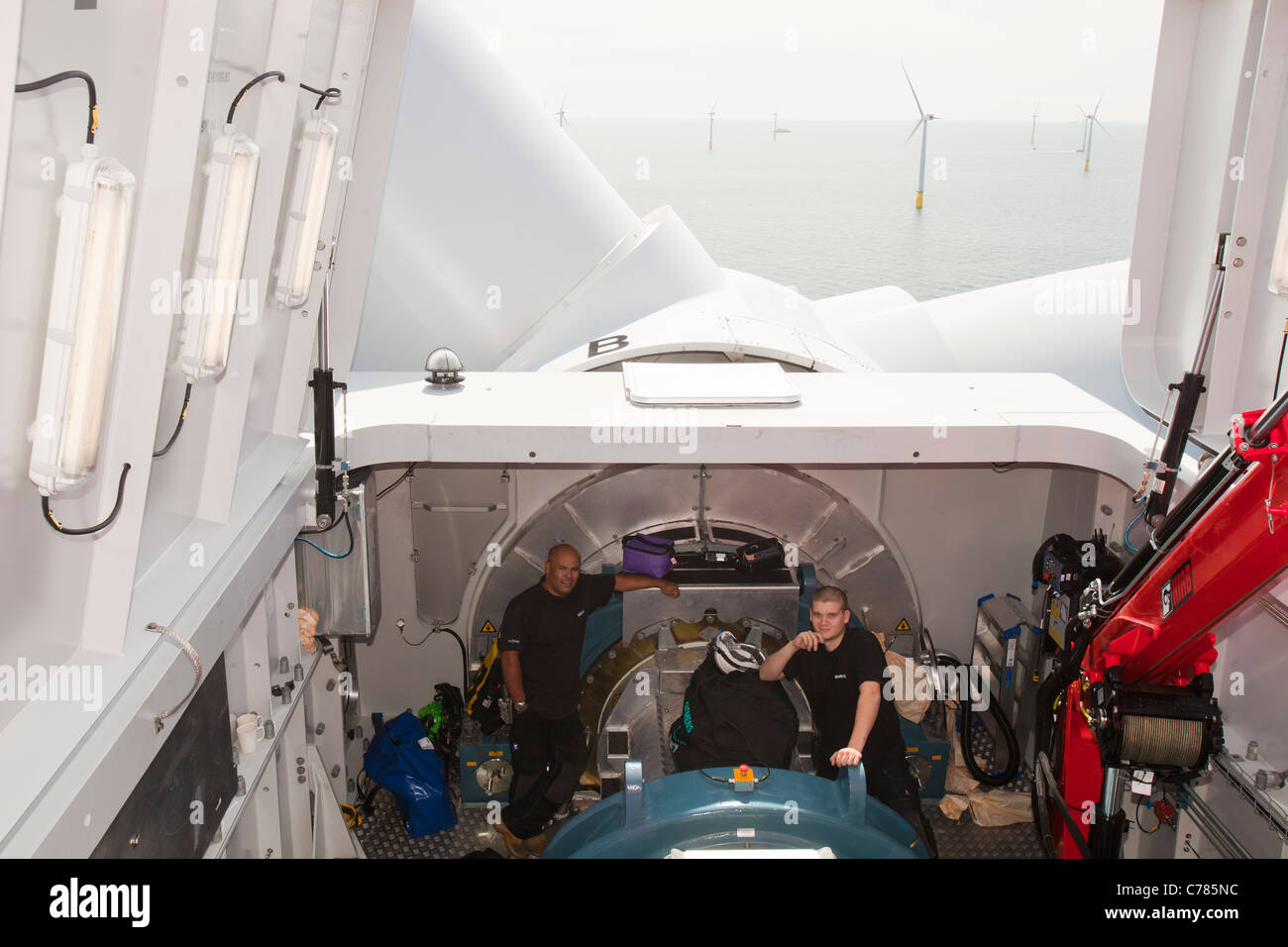 Engineers working in the nacelle of a wind turbine at the Walney offshore wind farm. The farm ...