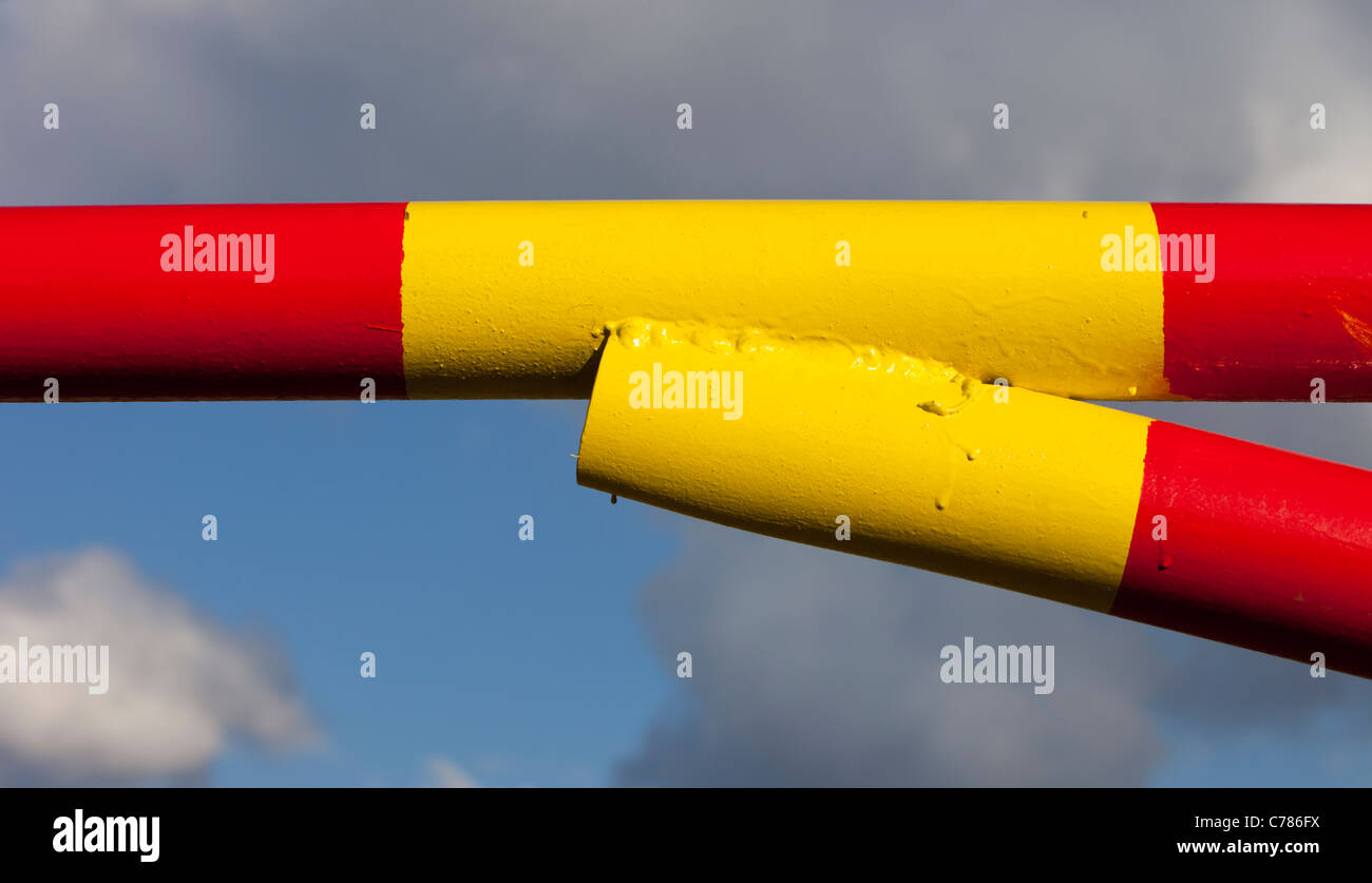 Closeup of red and yellow striped metal boom Stock Photo - Alamy