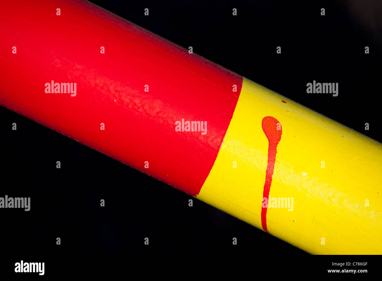 Closeup of red and yellow striped metal boom with paint fault Stock ...