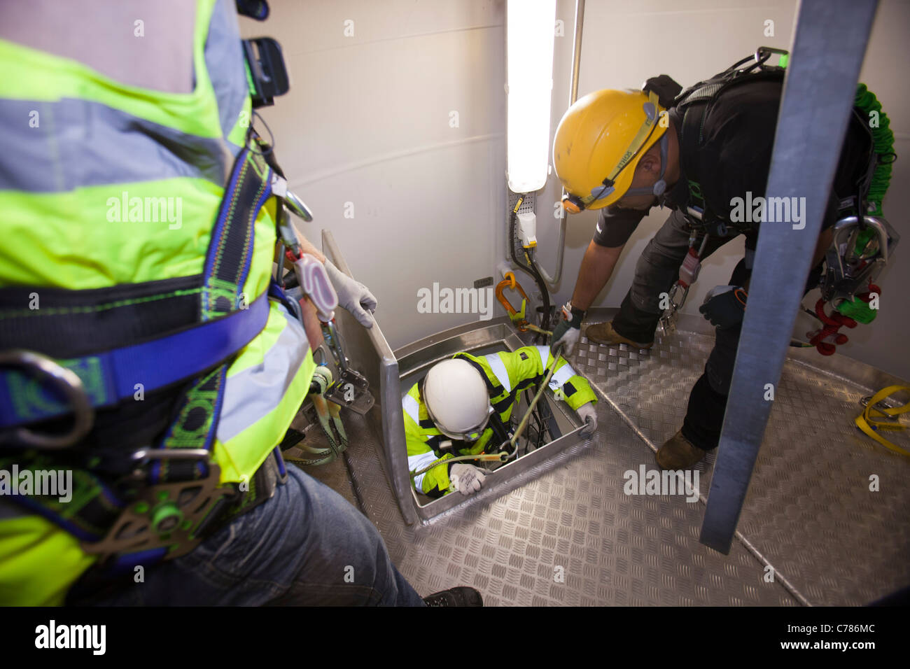 Workers in a wind turbine on the Walney offshore wind farm, UK Stock ...