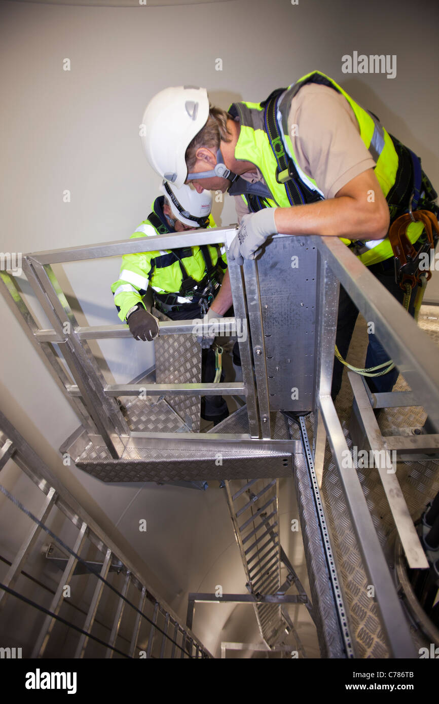 Workers in a wind turbine on the Walney offshore wind farm, UK Stock ...