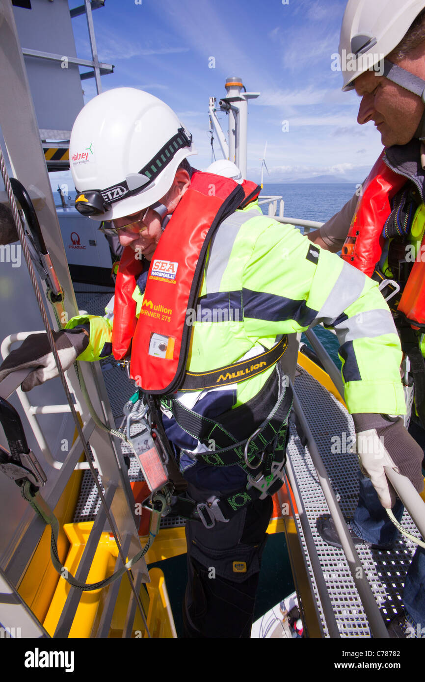 Health and safety workers on a wind turbine in the Walney offshore wind ...