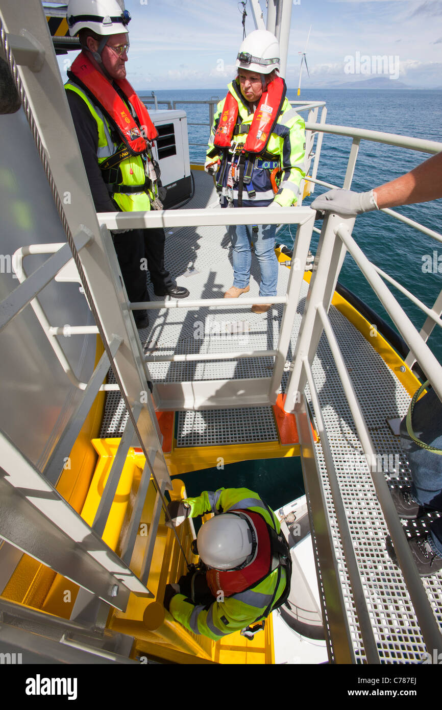 Health and safety workers on a wind turbine in the Walney offshore wind ...
