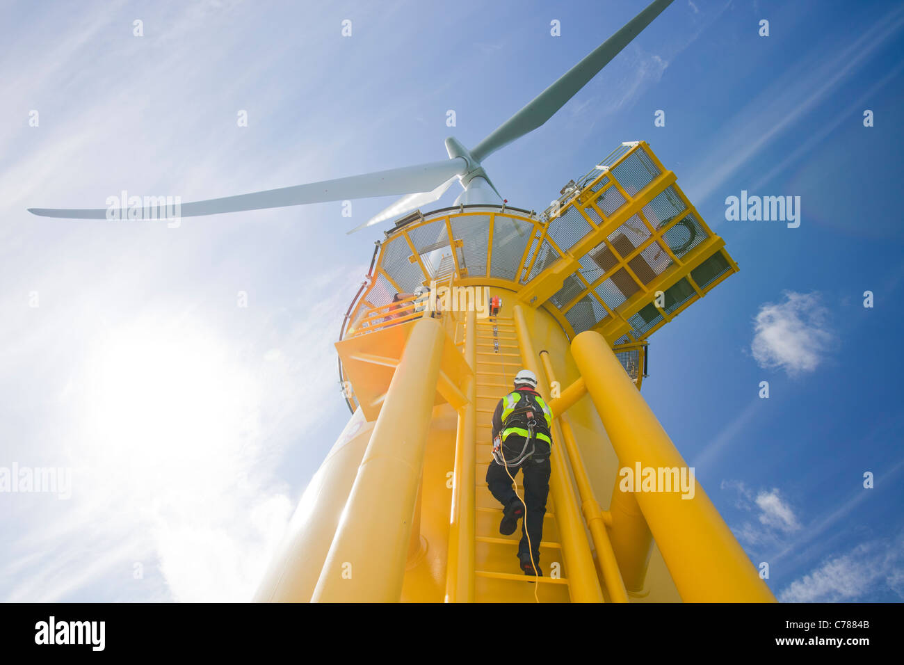 A worker climbing a wind turbine at the Walney offshore wind farm Stock ...