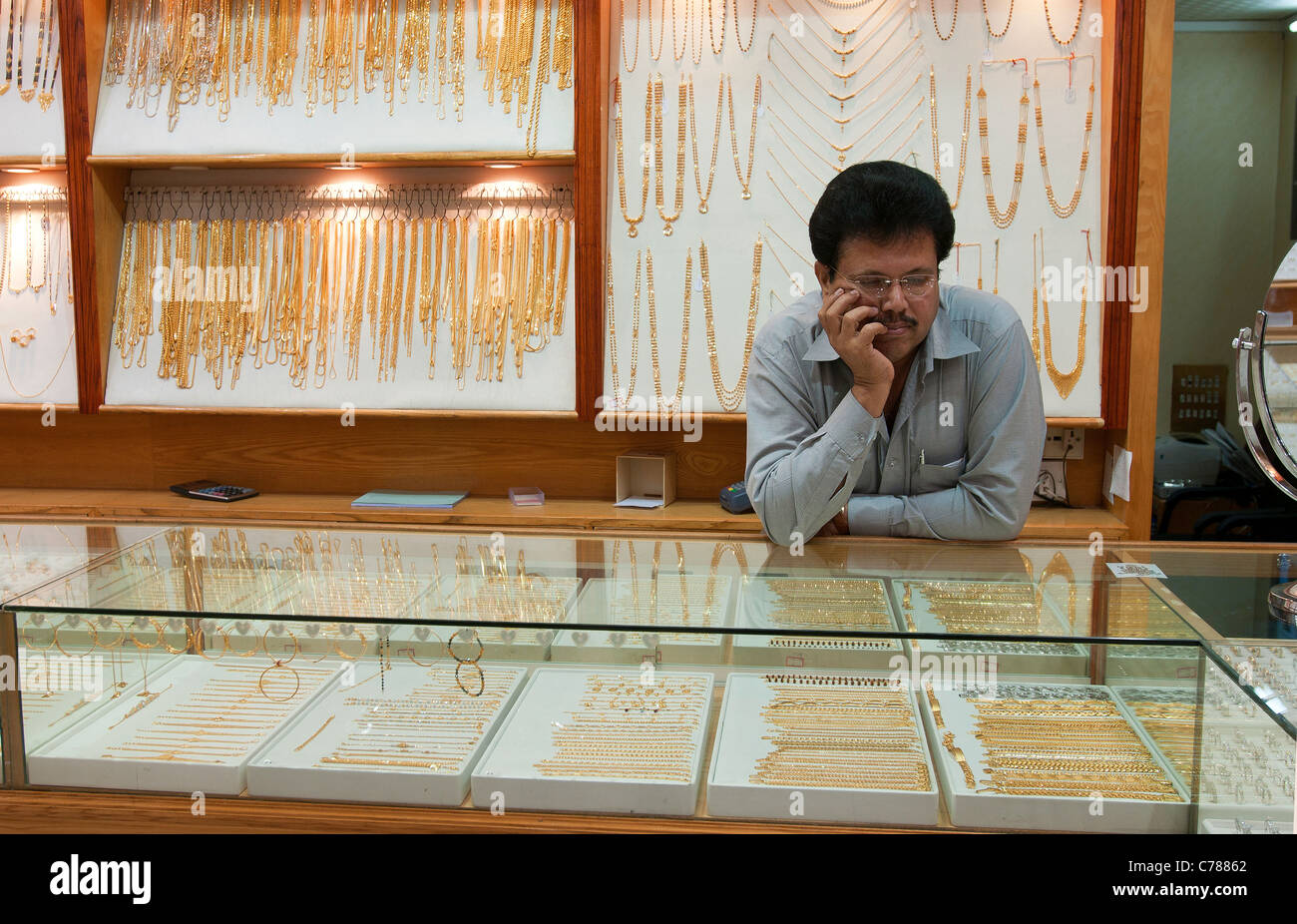 An Indian gold seller in Dubai gold souk Stock Photo - Alamy