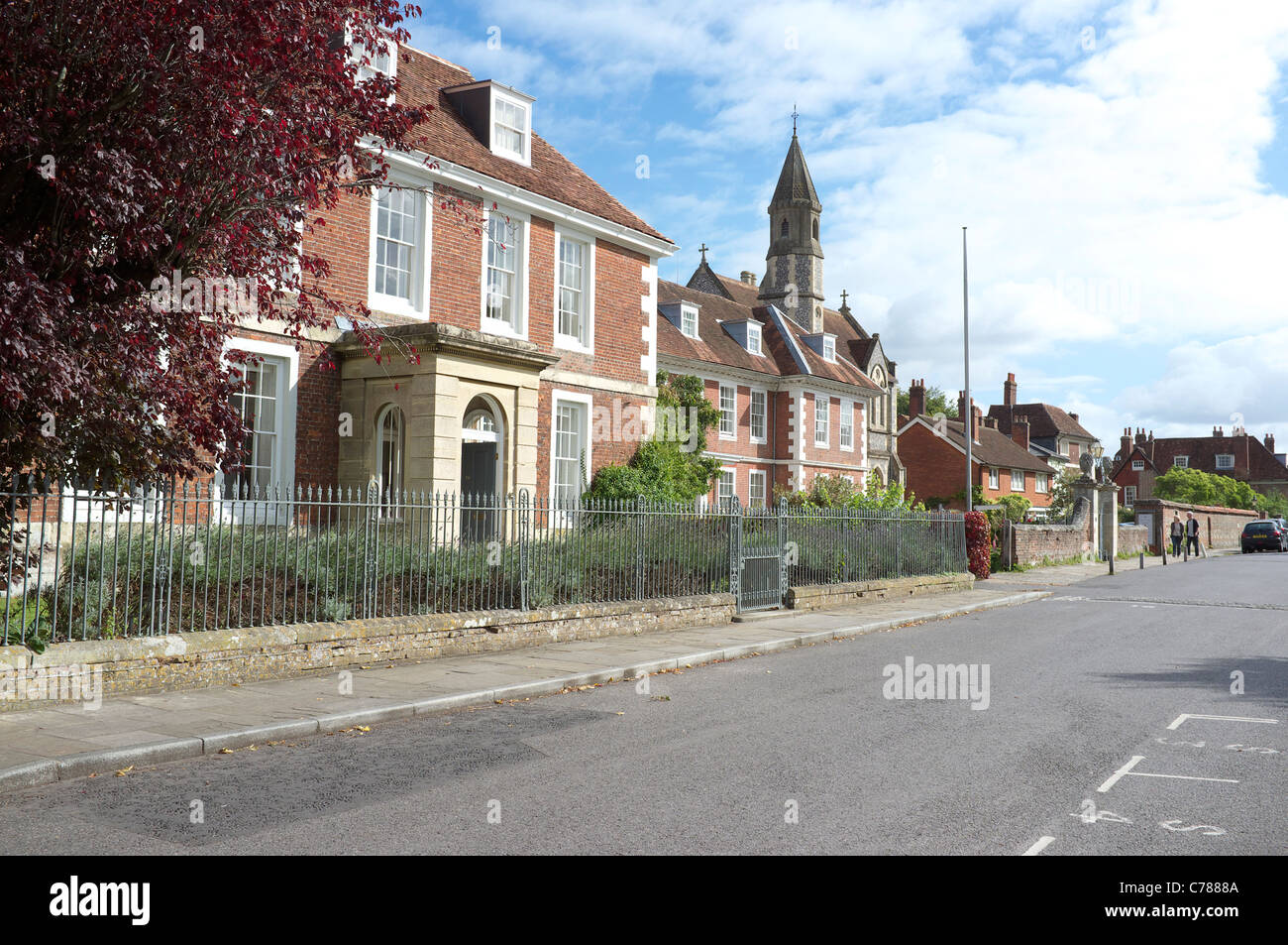 Iron railings, pavement and Sarum College in Salisbury Cathedral Close ...