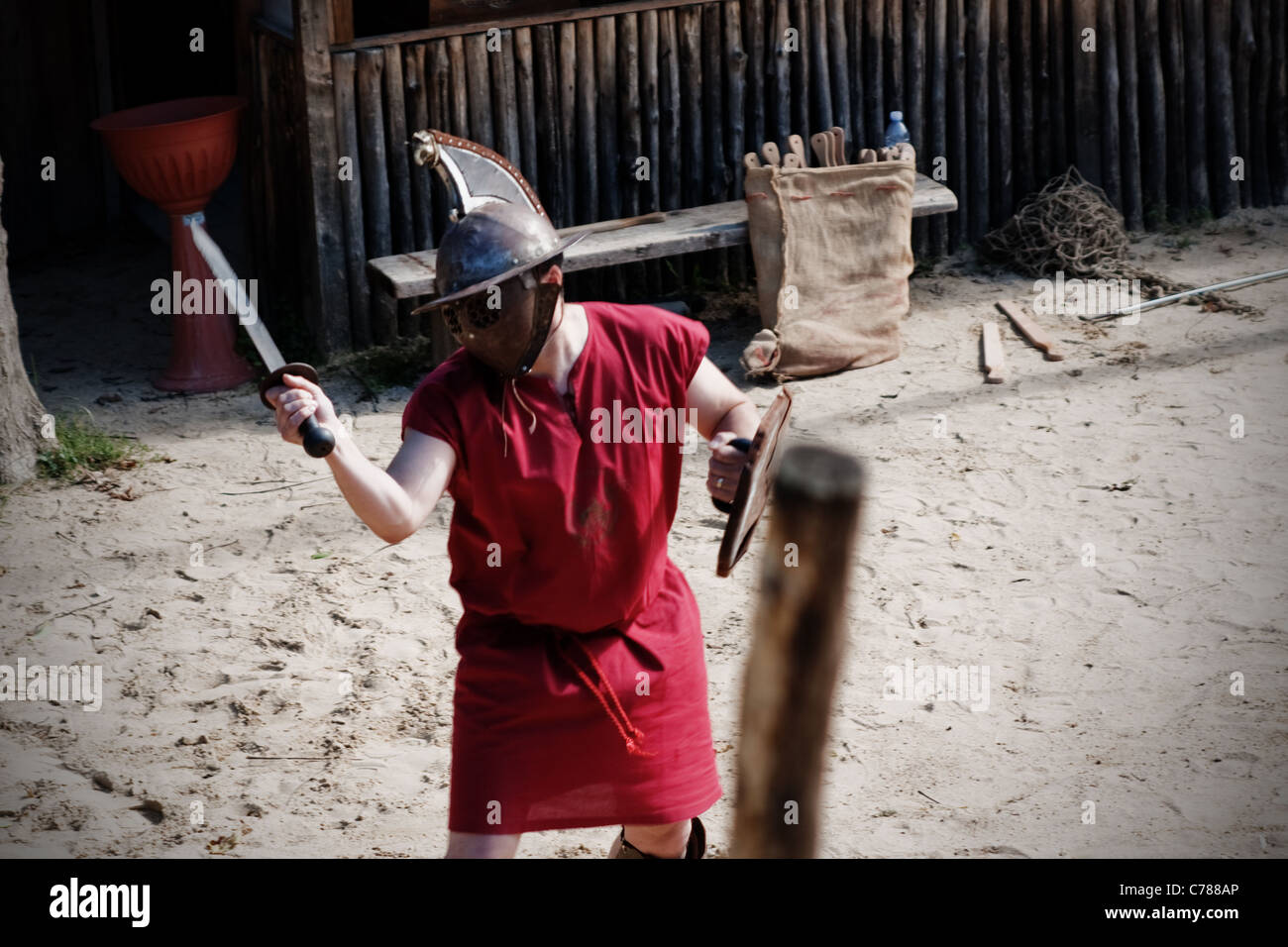 Gladiators in training wear purple tunics, sandals and helmets that are ...
