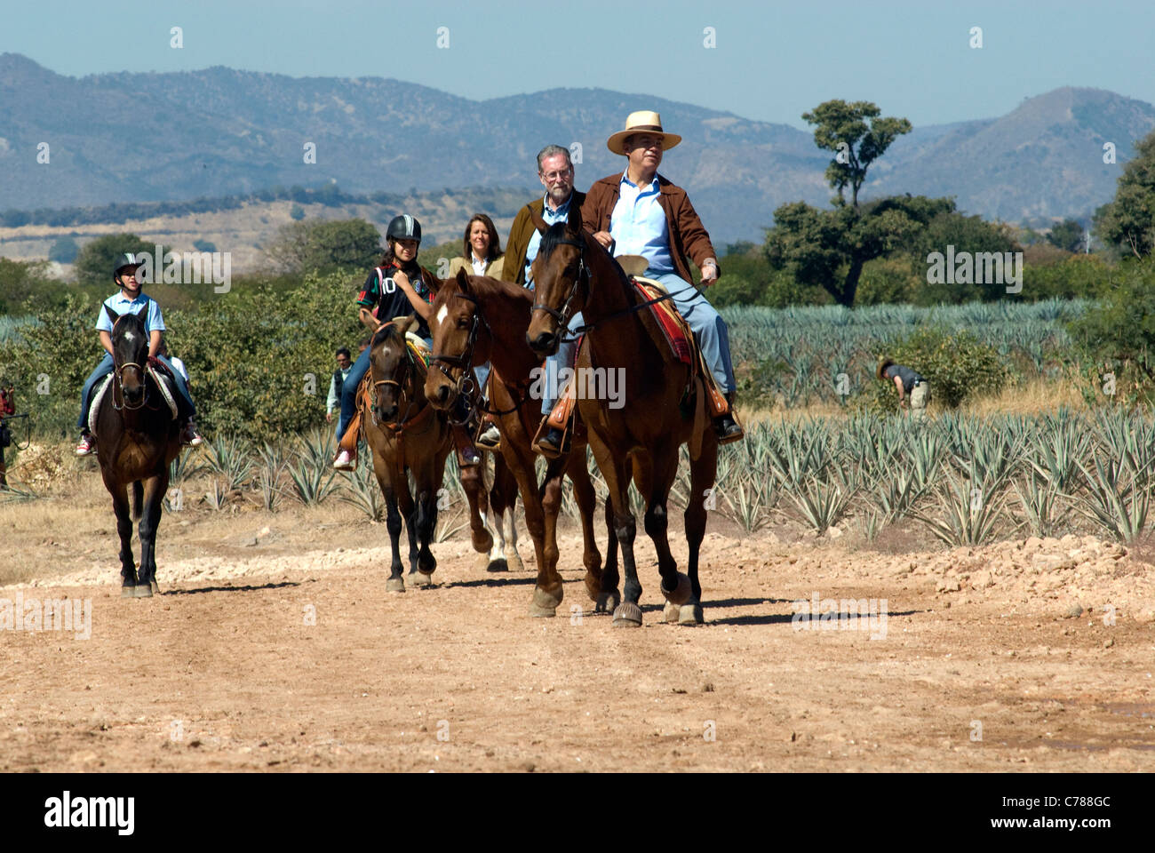 President Calderon with his family and Peter Greenberg riding horses on ...