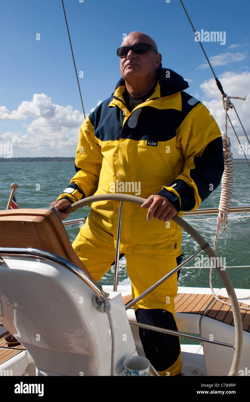 Sailer at yacht helm Stock Photo - Alamy