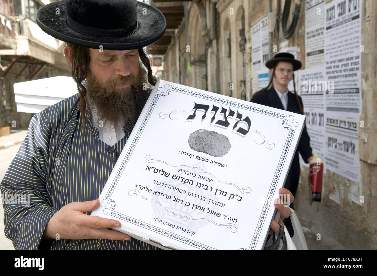 A Hasidim Orthodox Jewish man holding a box of Shmura Matzo / Matzo ...