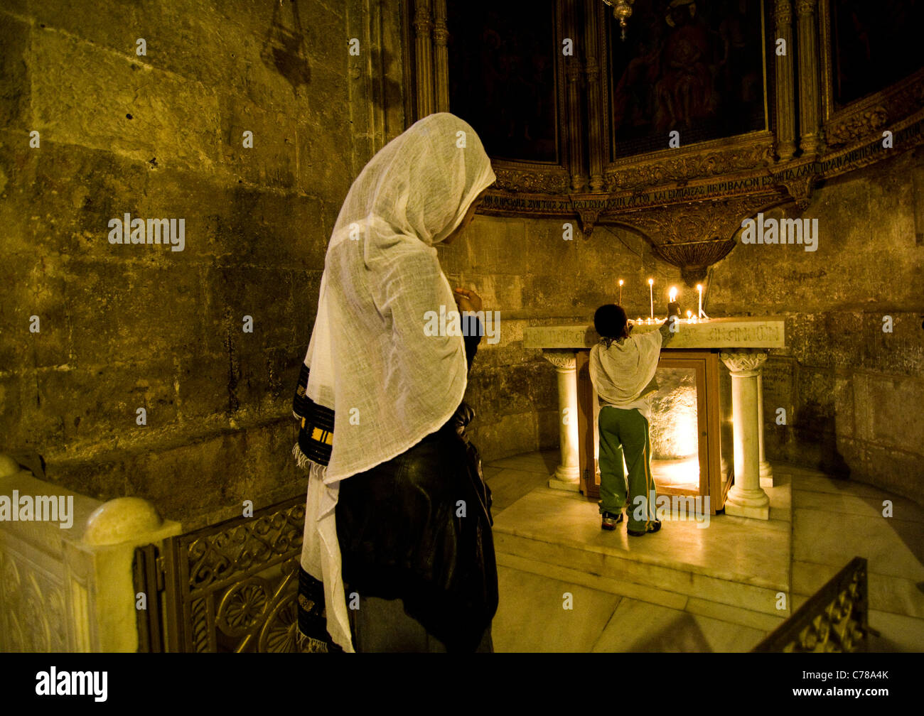 Ethiopian pilgrims pray in a small chapel inside the church of the holy ...