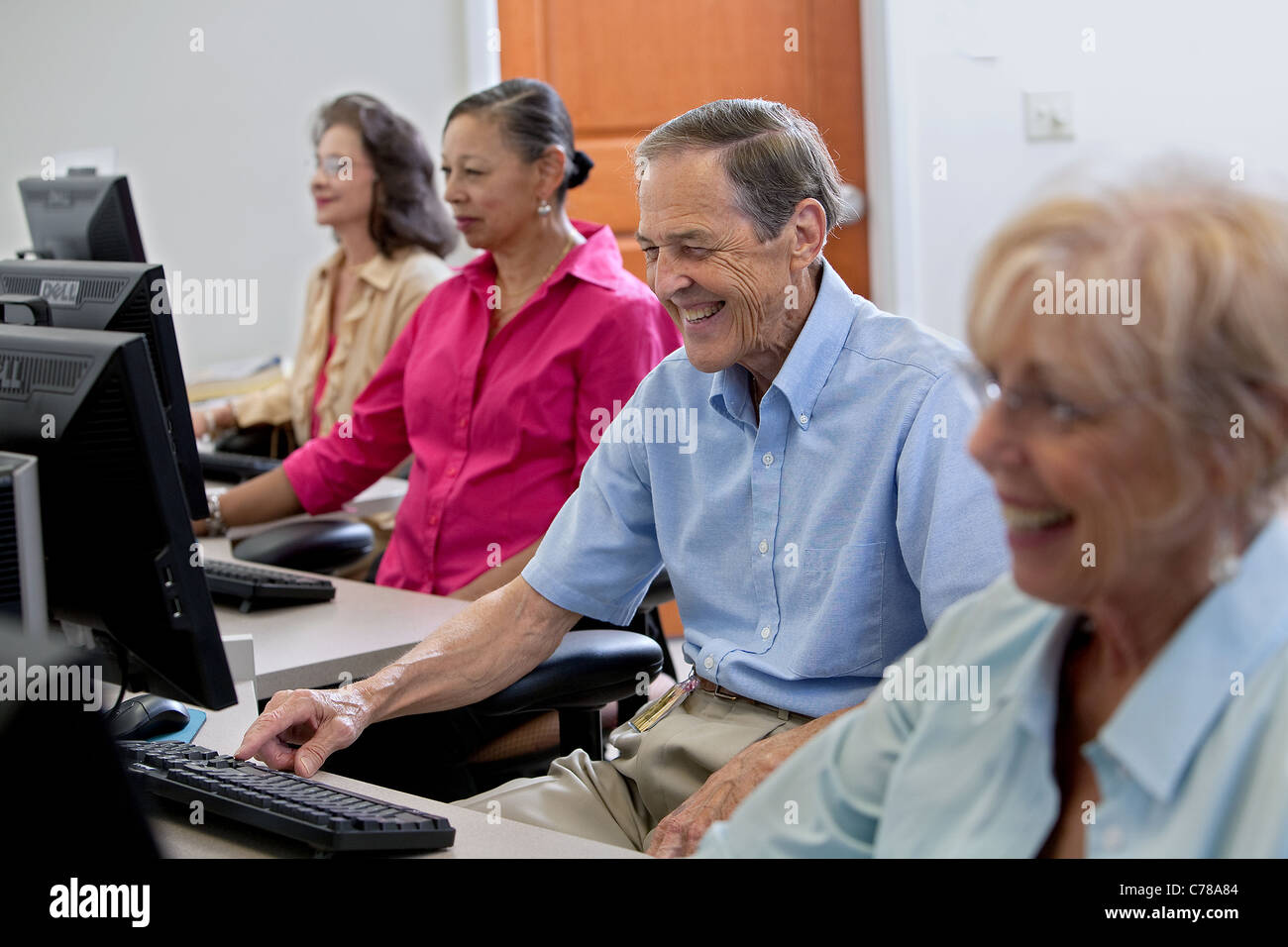 Senior citizens work on a computer Stock Photo - Alamy