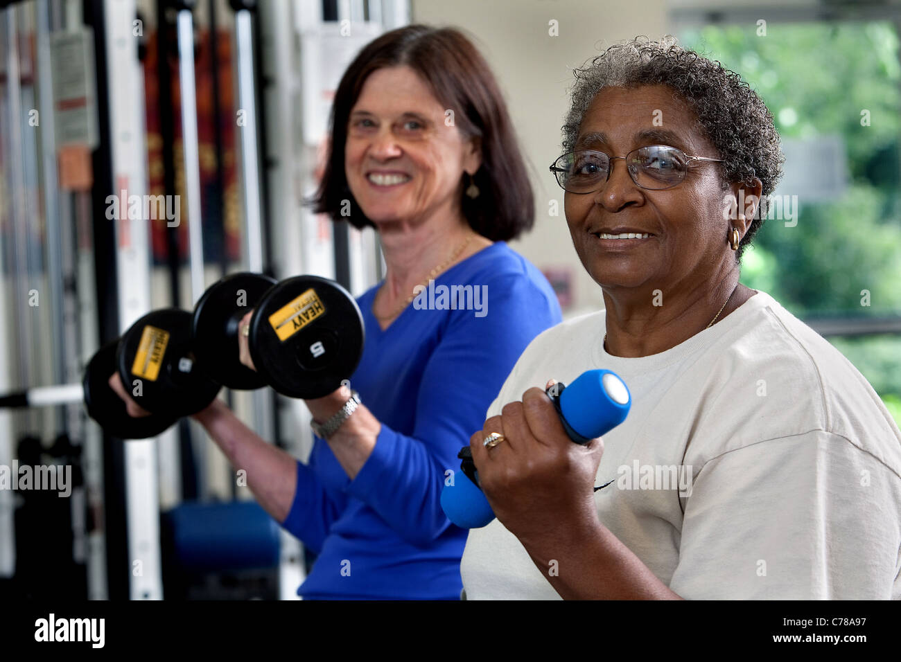 Senior citizens lift weights in a gym Stock Photo - Alamy