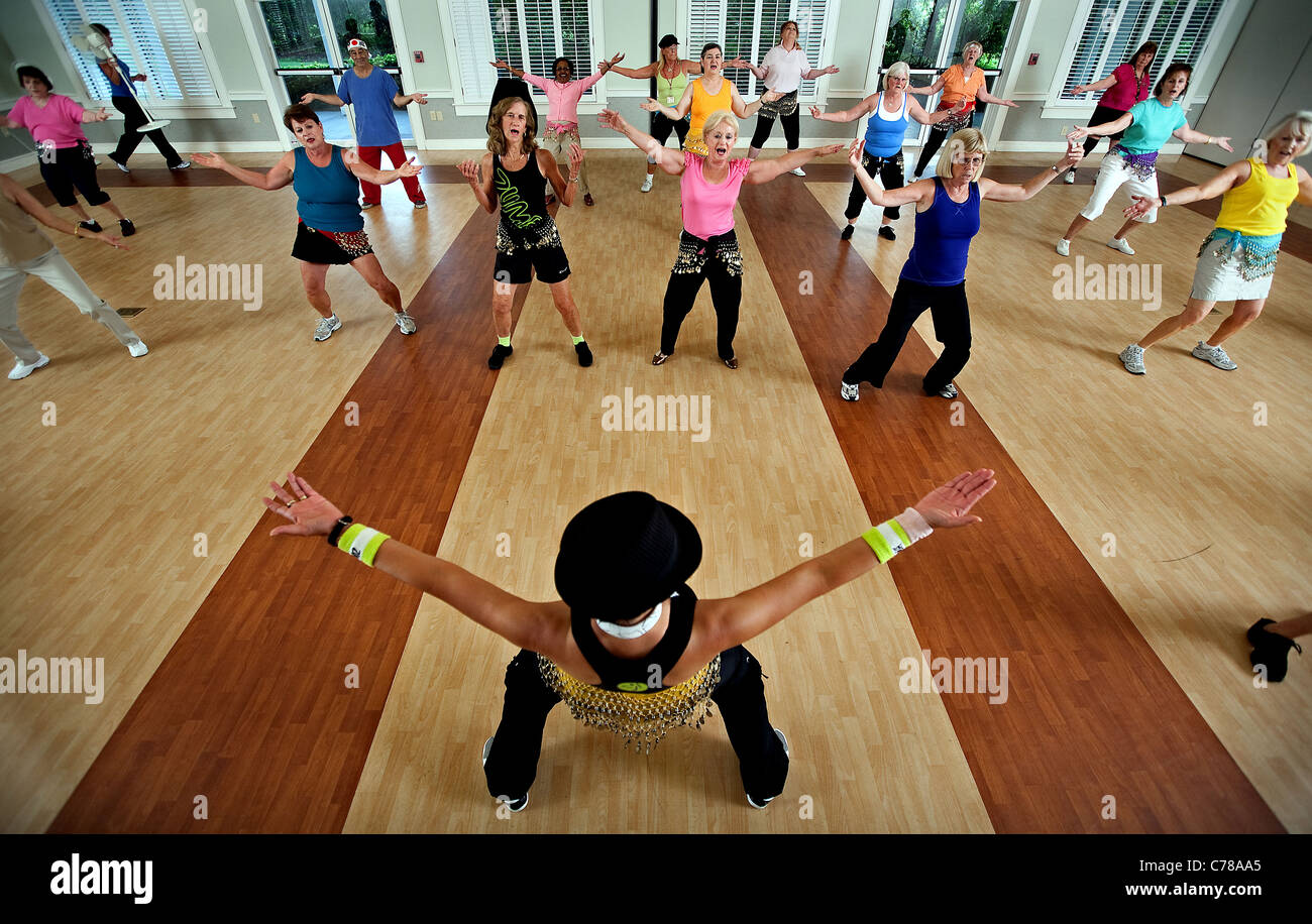 A Zumba teacher leads her class in a senior citizen center Stock Photo ...