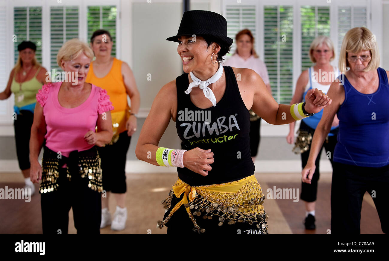 A Zumba teacher leads her class in a senior citizen center Stock Photo ...