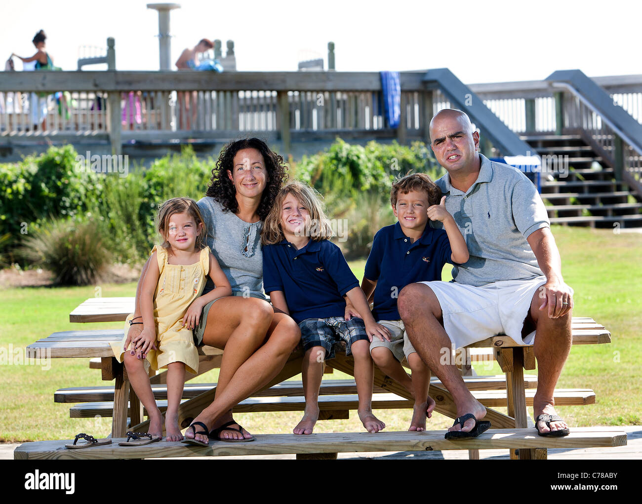 A family poses on a picnic table by the Isle of Palms beach Stock Photo ...