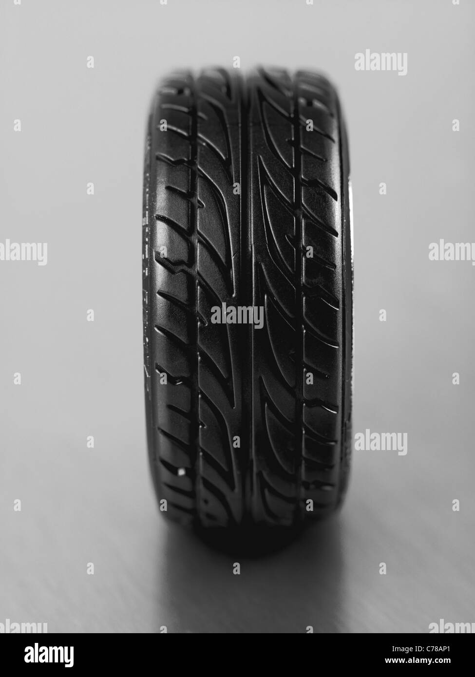Rubber tyres with sports rims on a silver background Stock Photo - Alamy