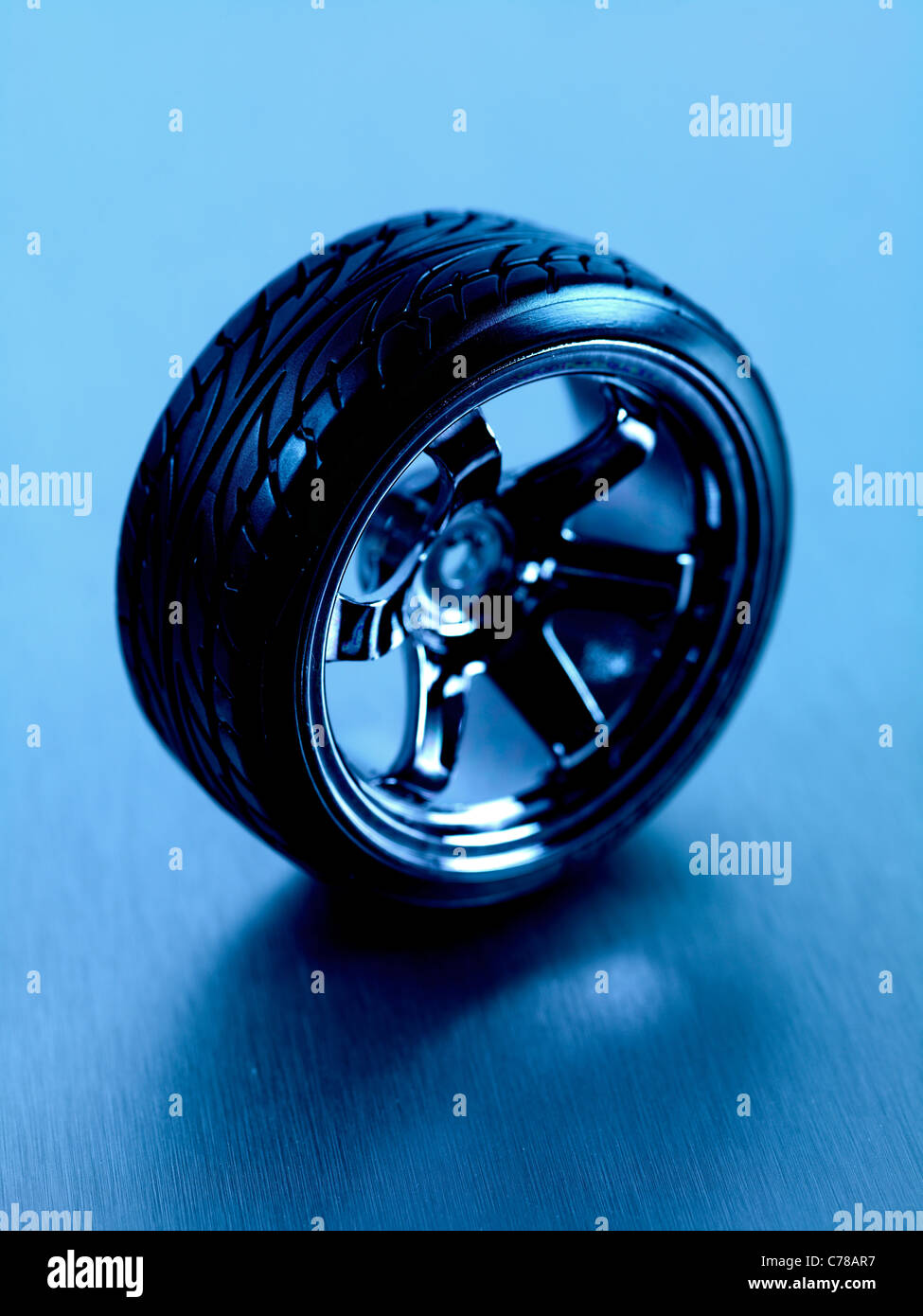 Rubber tyres with sports rims on a silver background Stock Photo - Alamy