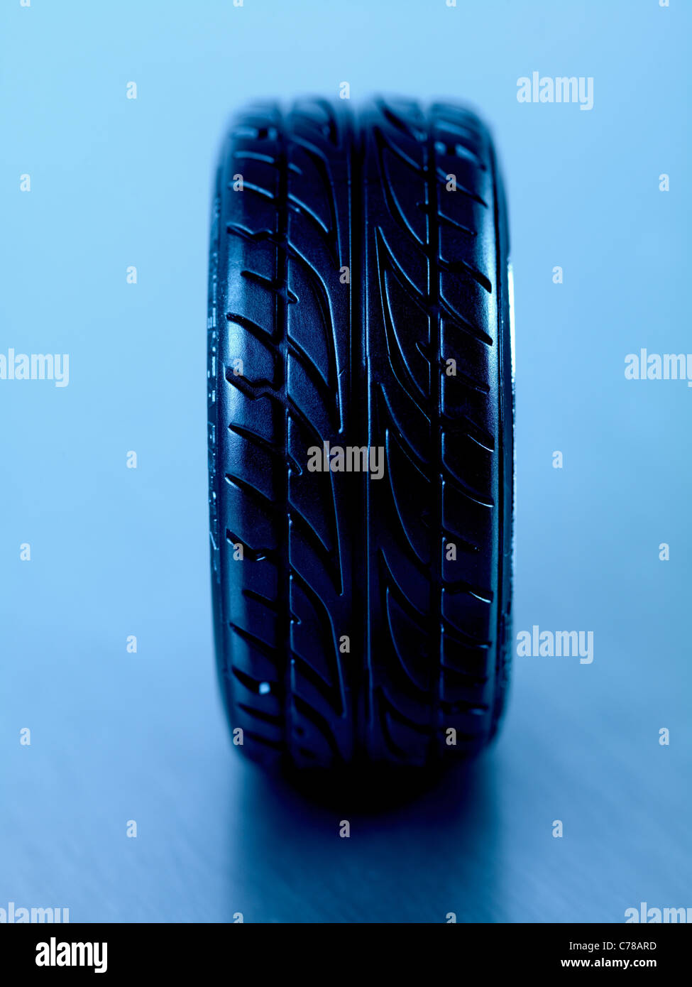 Rubber tyres with sports rims on a silver background Stock Photo - Alamy