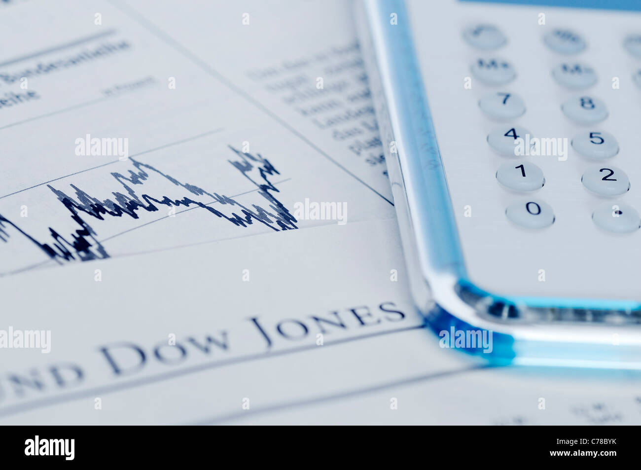 Calculator on the financial section of a business newspaper Stock Photo ...