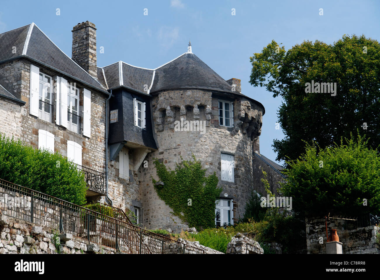 Wall and tower of the medieval city of Domfront, turned into homes ...