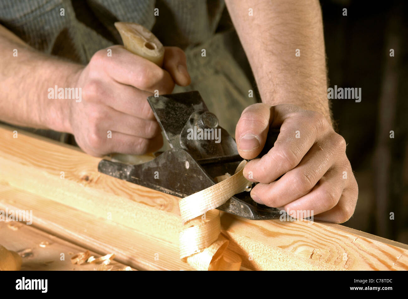 Hands of a carpenter planed wood, workplace Stock Photo - Alamy