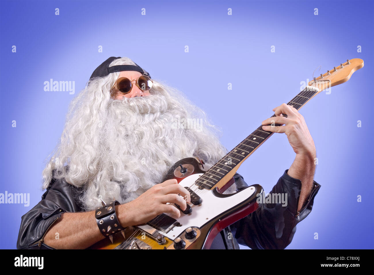 Rocker-man with the guitar on blue background Stock Photo - Alamy