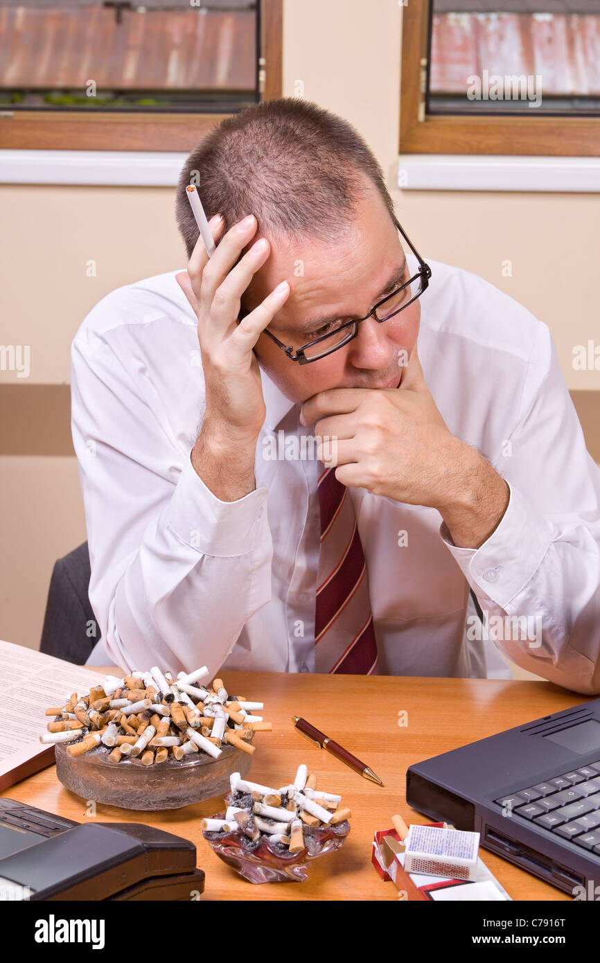 Worried businessman with cigarette Stock Photo - Alamy
