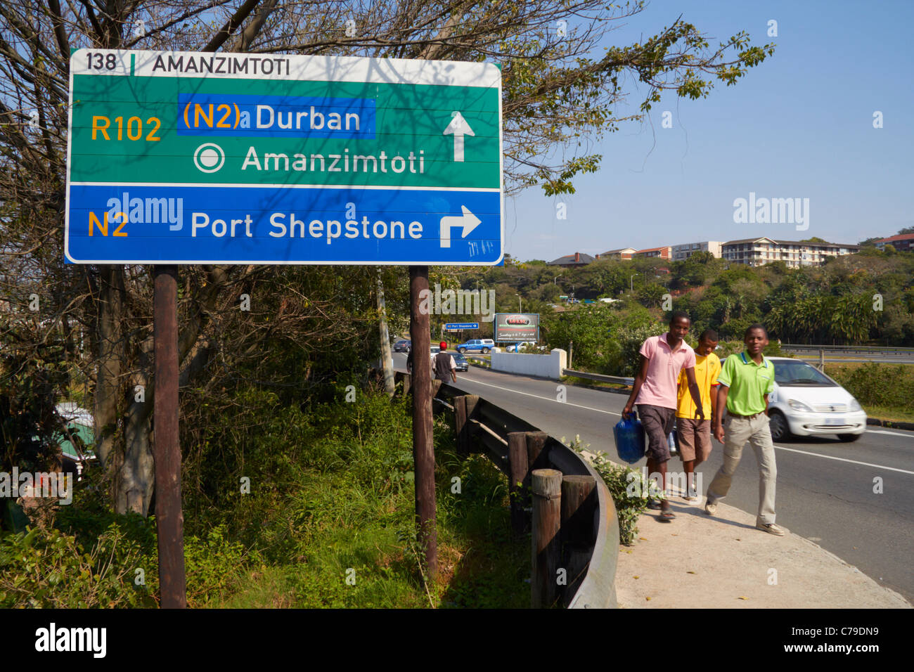 Boys walking past road sign at Amanzimtoti, KwaZulu-Natal, South Africa ...